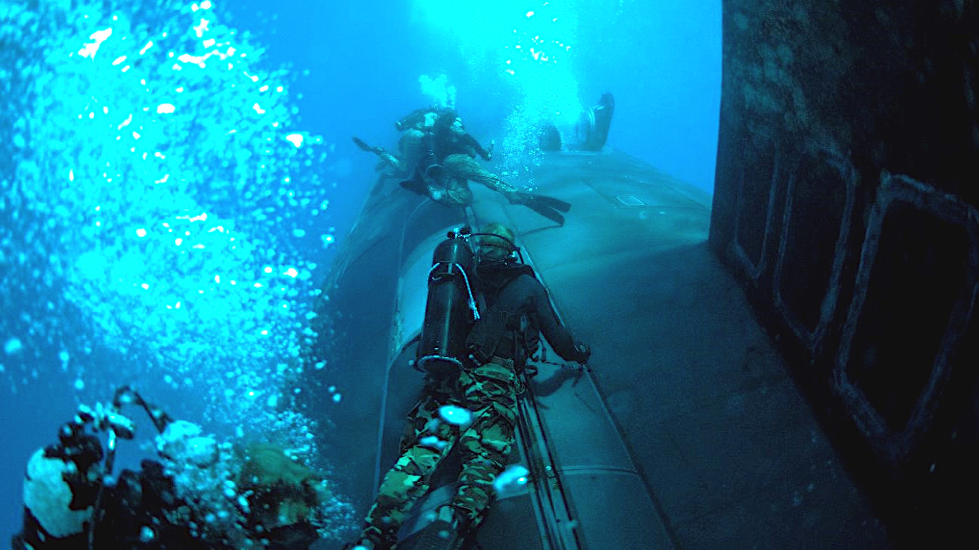 Check Out These Flag-Bearing Navy SEALs Training With A Submerged Submarine